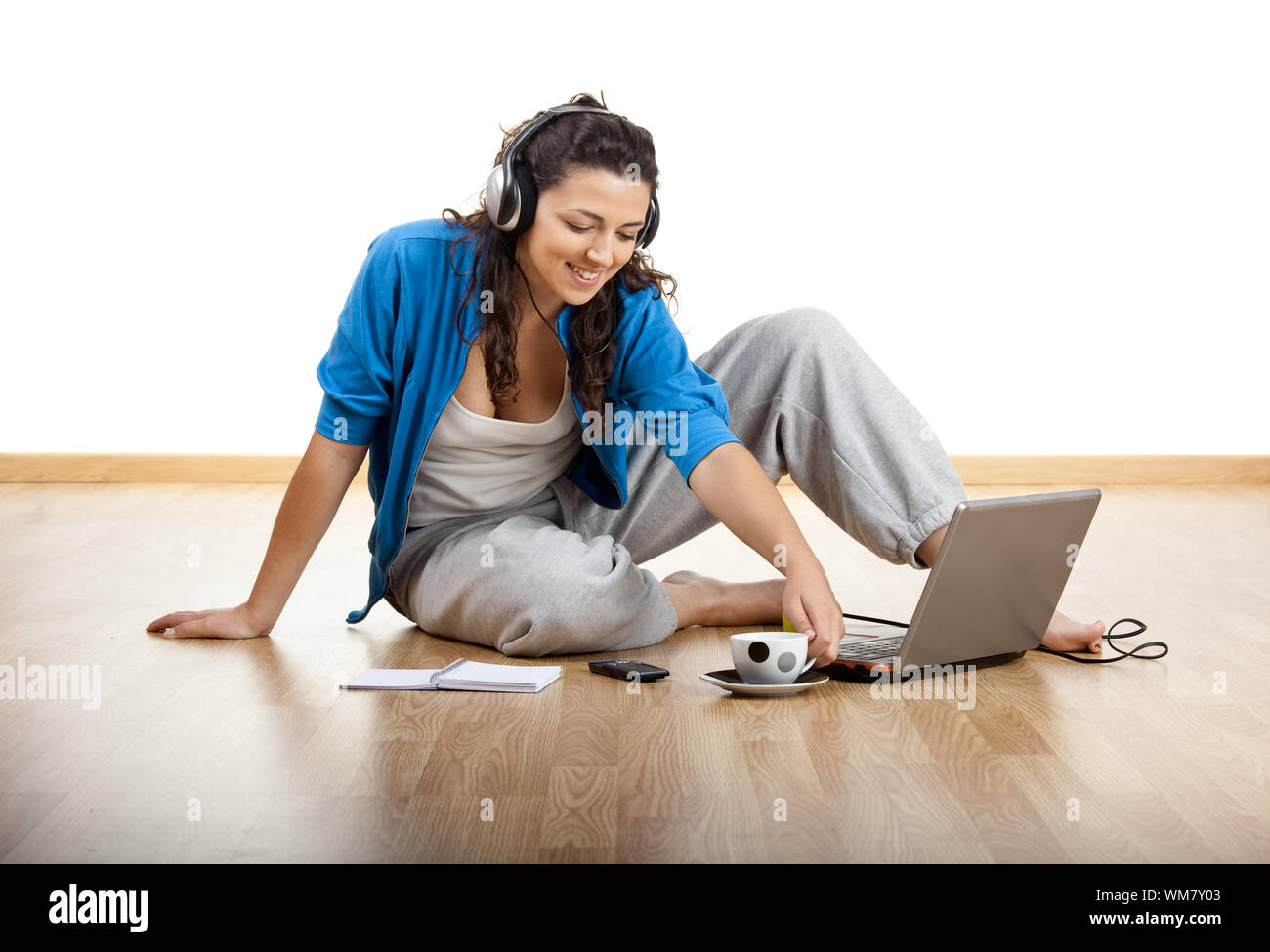 Girl sitting on floor and working with a laptop Stock Photo - Alamy