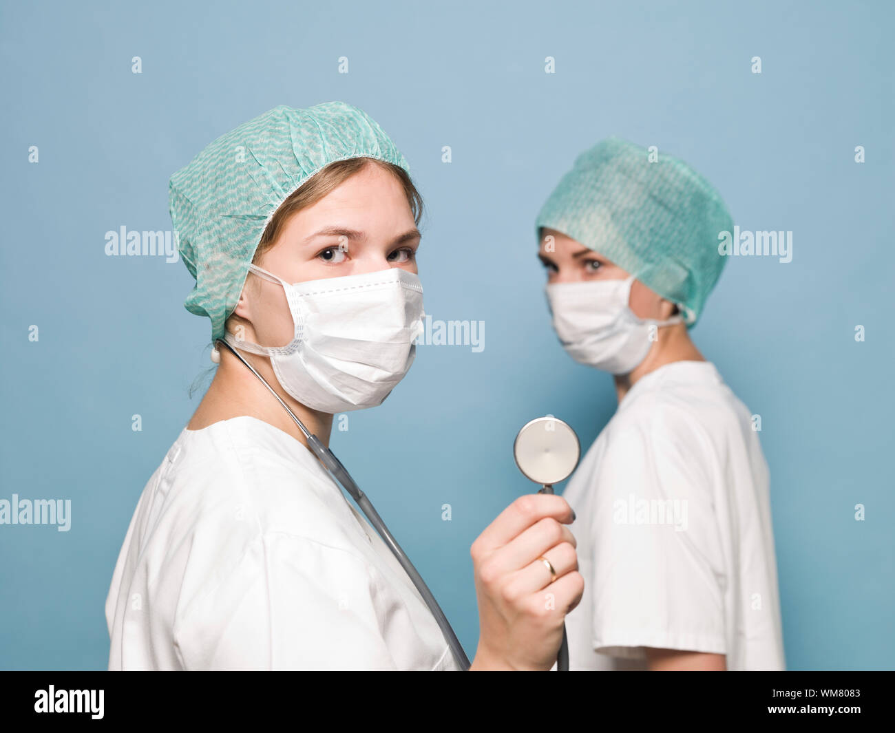 Two female nurses with surgical masks and a stethoscope Stock Photo - Alamy