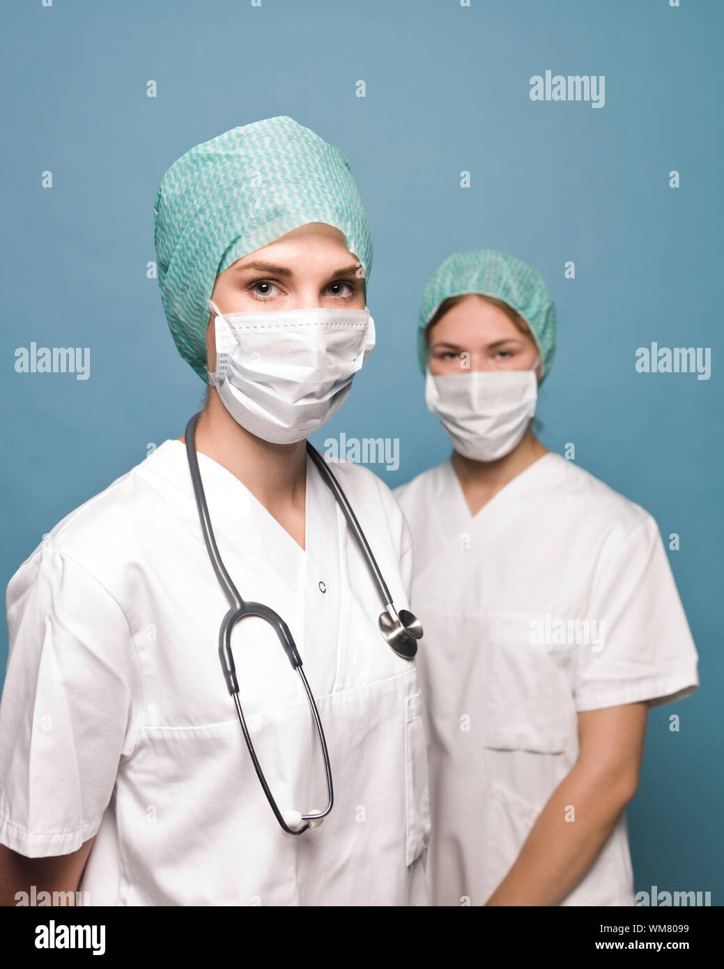 Two nurses with surgical masks and a stethoscope Stock Photo - Alamy