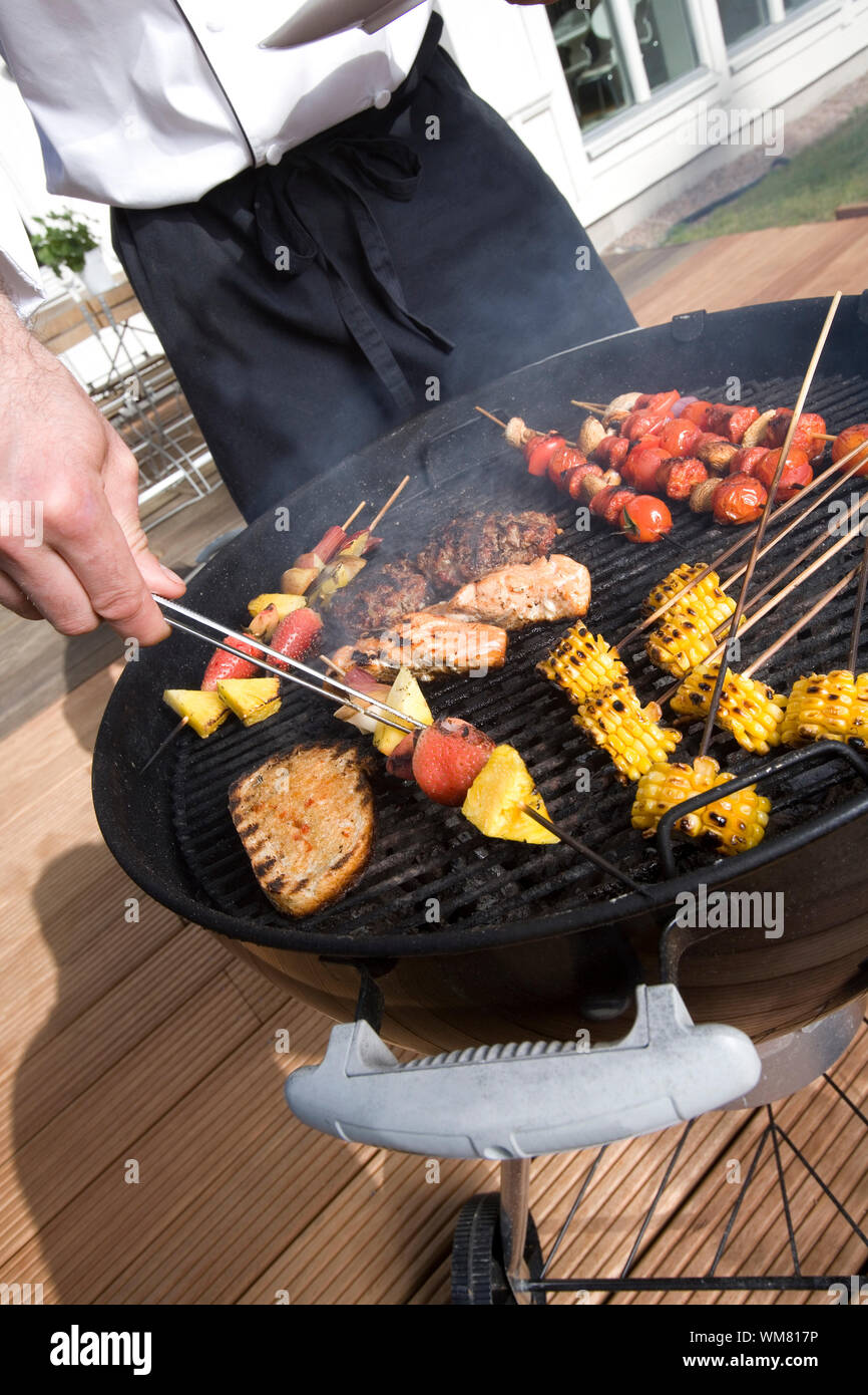 Man at the grill outdoor Stock Photo - Alamy