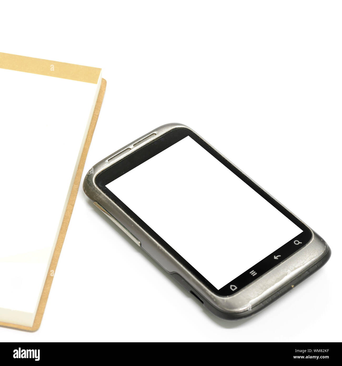 used smartphone with note book on a white background Stock Photo - Alamy