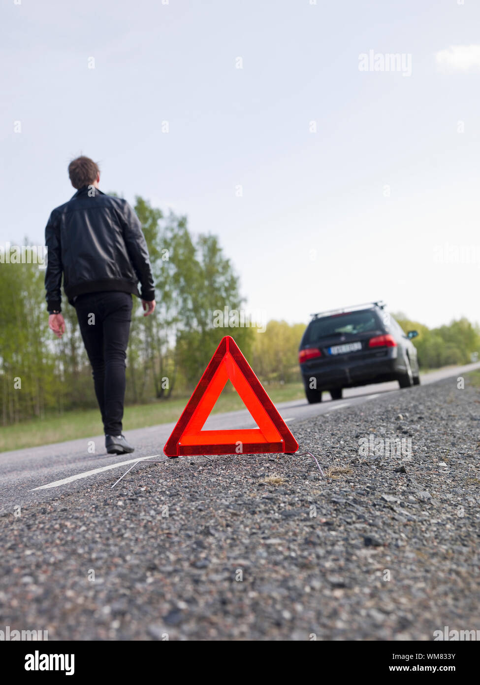 Warning triangle in front of a car breakdown Stock Photo - Alamy