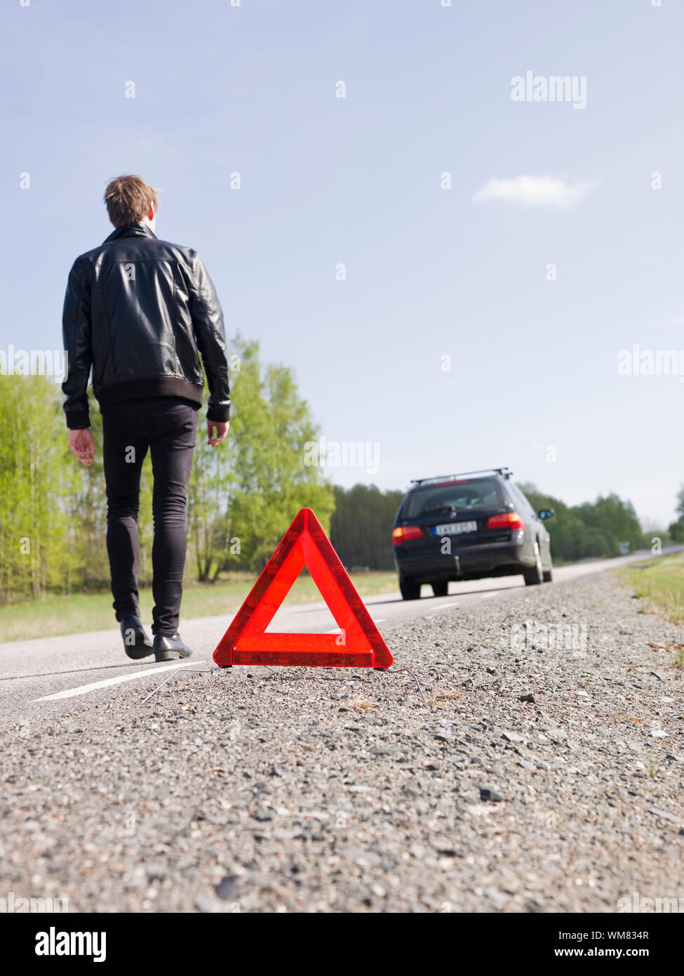 Warning triangle in front of a car breakdown Stock Photo - Alamy