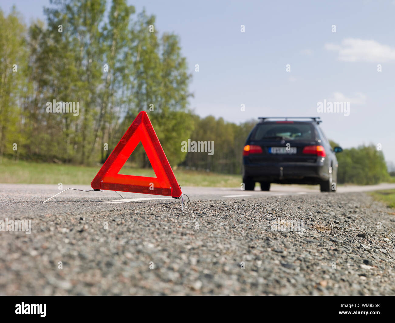 Warning triangle in front of a car breakdown Stock Photo - Alamy