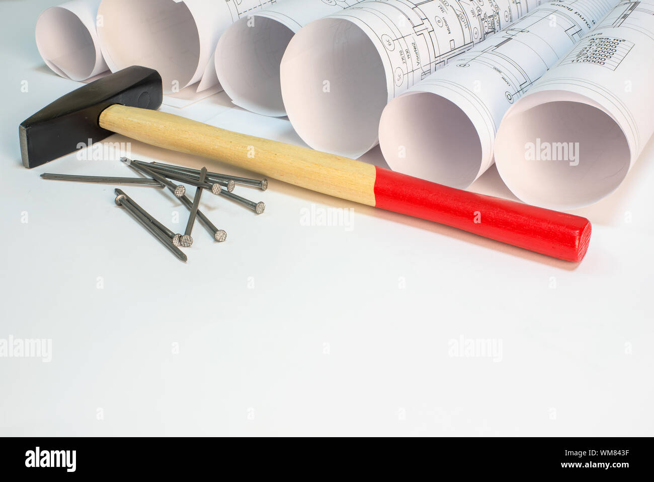 Drawing rolls, hammer and nails on white surface Stock Photo - Alamy