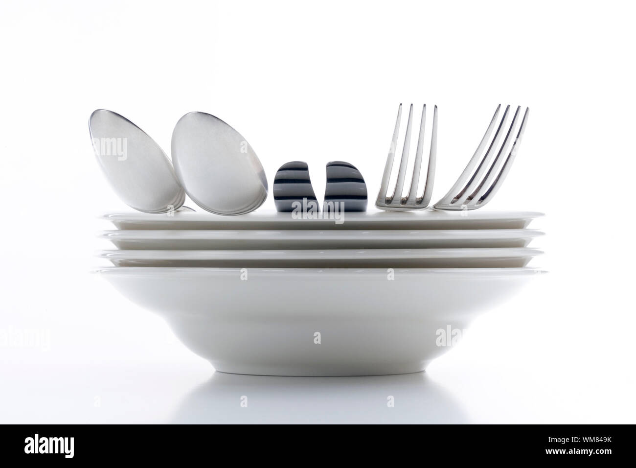 white plates with silverware isolated on white Stock Photo - Alamy