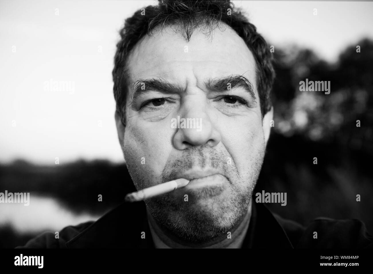 Man smoking cigarette hi-res stock photography and images - Alamy