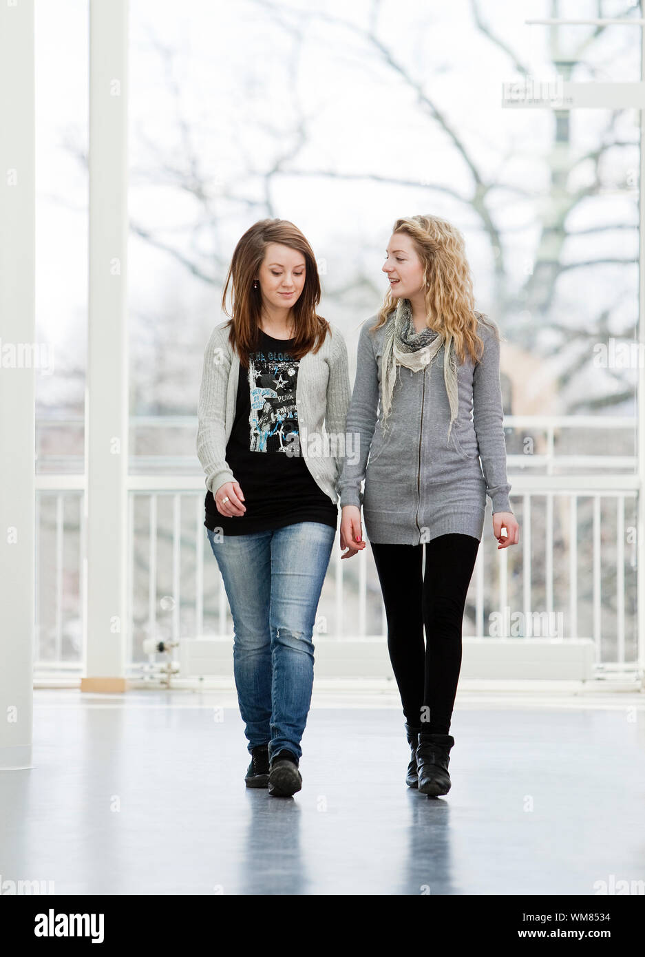 two girls walking Stock Photo - Alamy