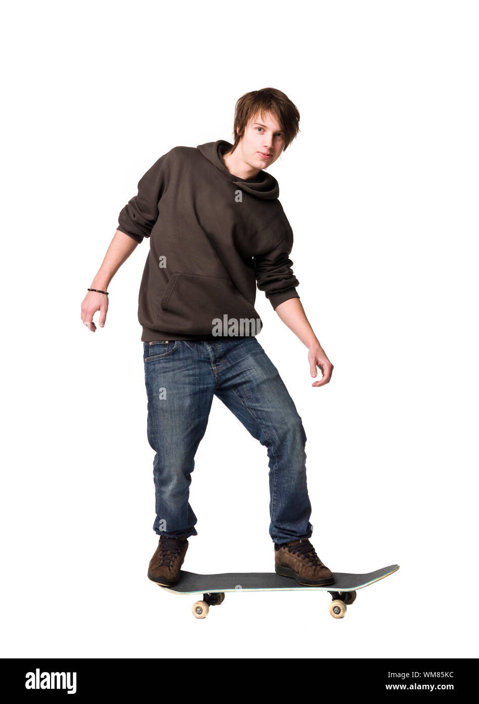 Boy standing on a skateboard Stock Photo - Alamy