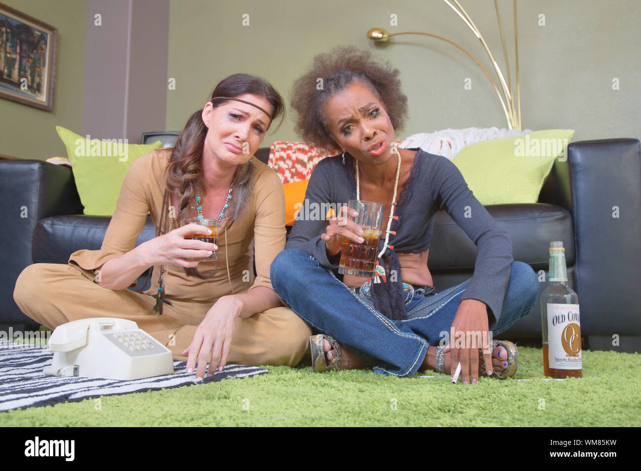 Pair of miserable 1960s women holding drinks Stock Photo - Alamy