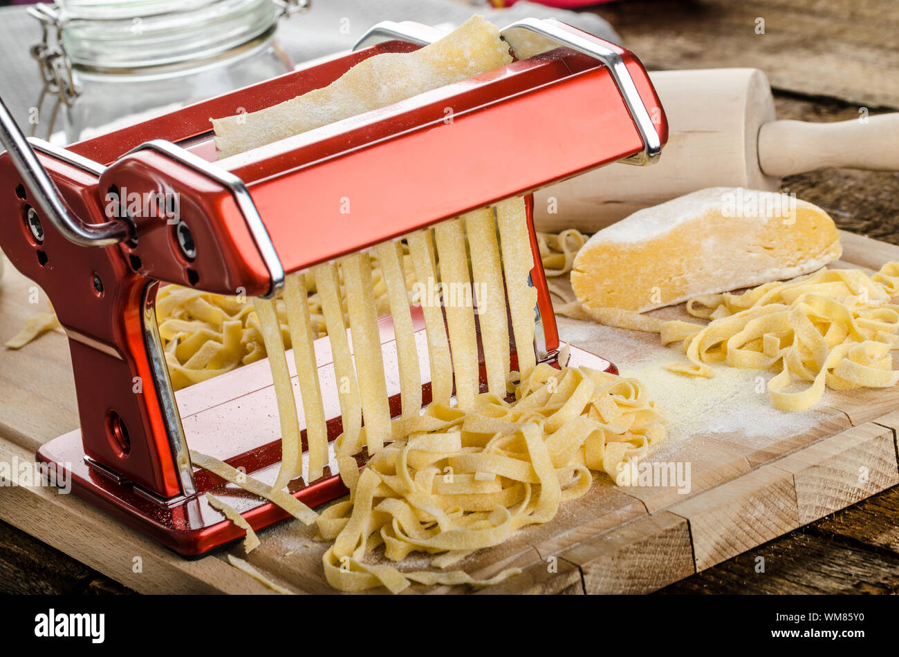 Production of homemade pasta Italian pasta grinder, wood board, rolling ...