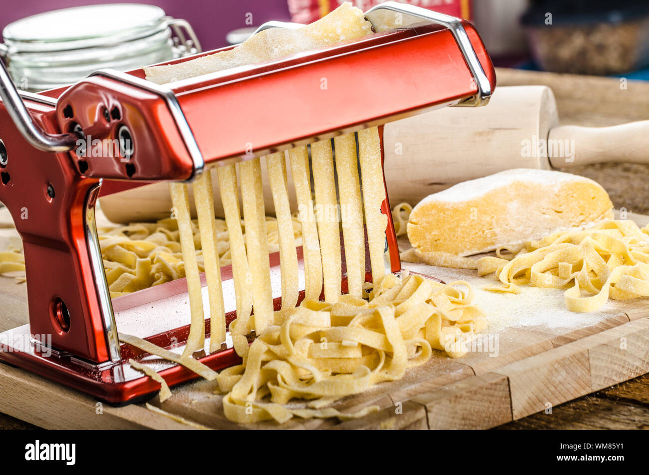 Production of homemade pasta Italian pasta grinder, wood board, rolling ...