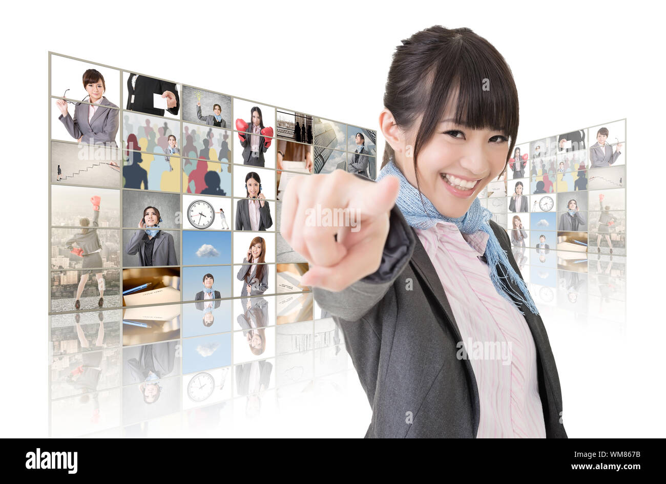 Confident Asian business woman point at you standing in front of TV ...