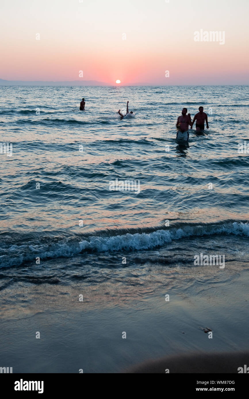 Swimming and fun in the sea by sunset Stock Photo - Alamy