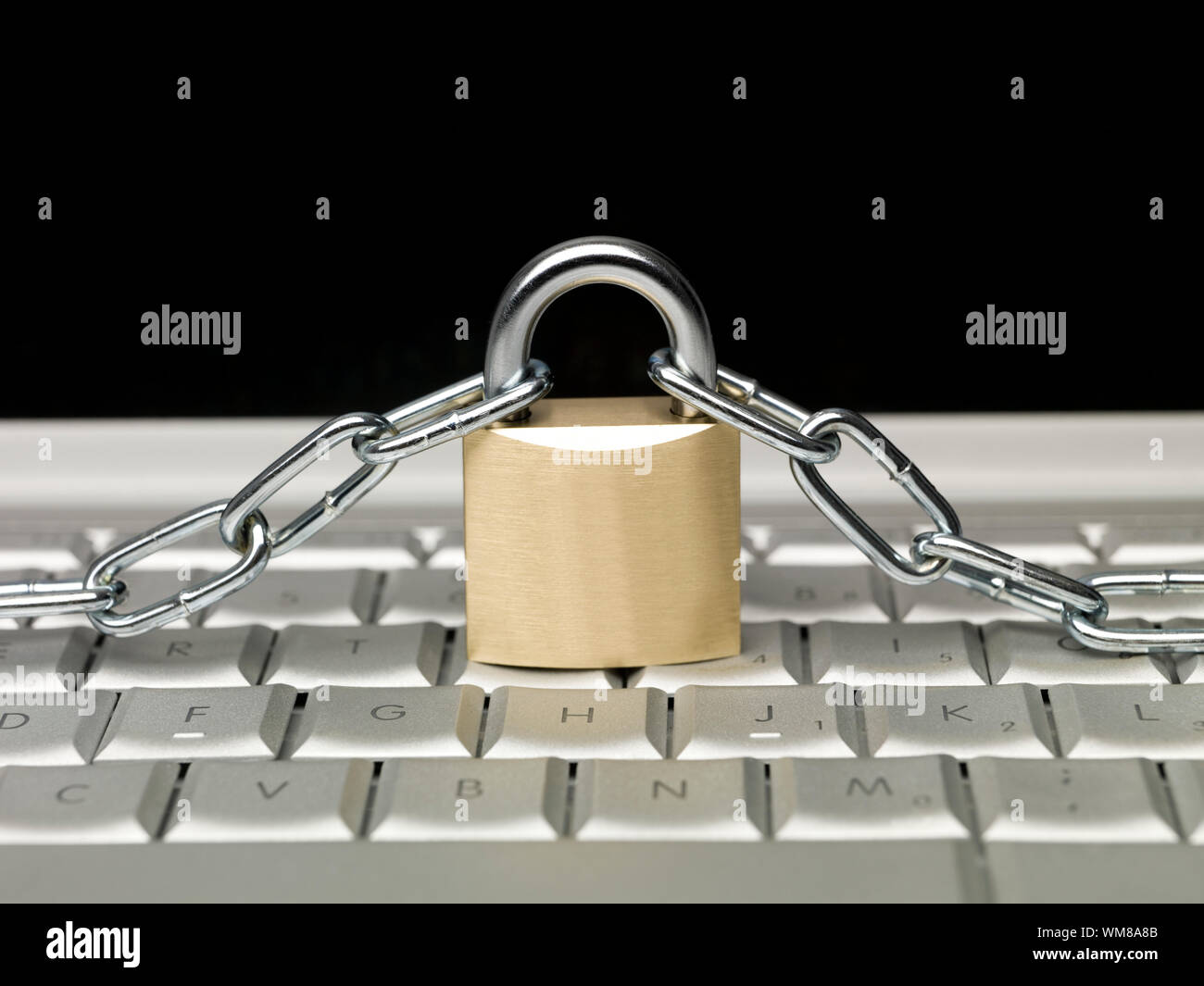Chain and a lock on a keyboard Stock Photo - Alamy