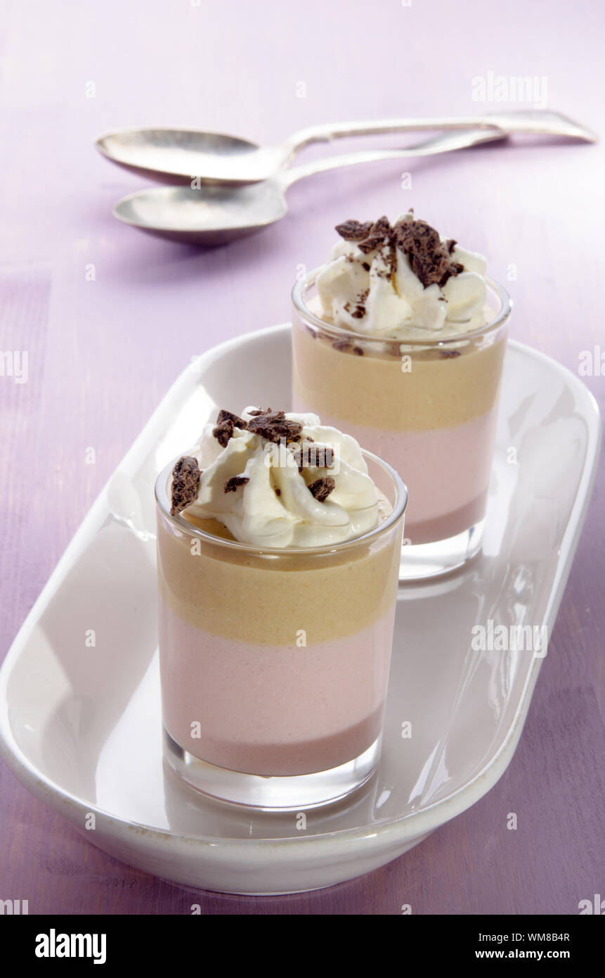 strawberry caramel dessert with broken chocolate and whipped cream in a ...