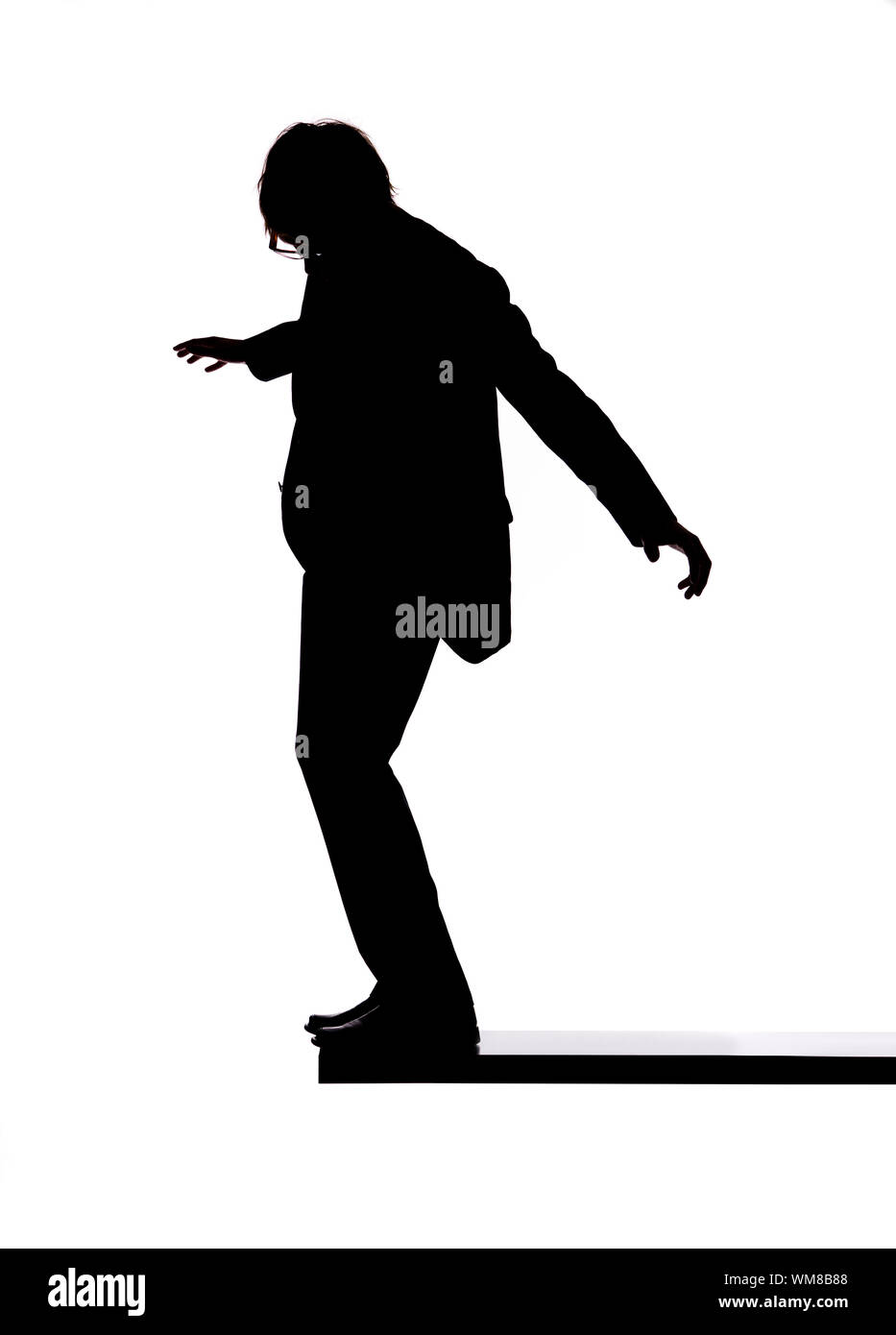 Man losing his balance Stock Photo - Alamy