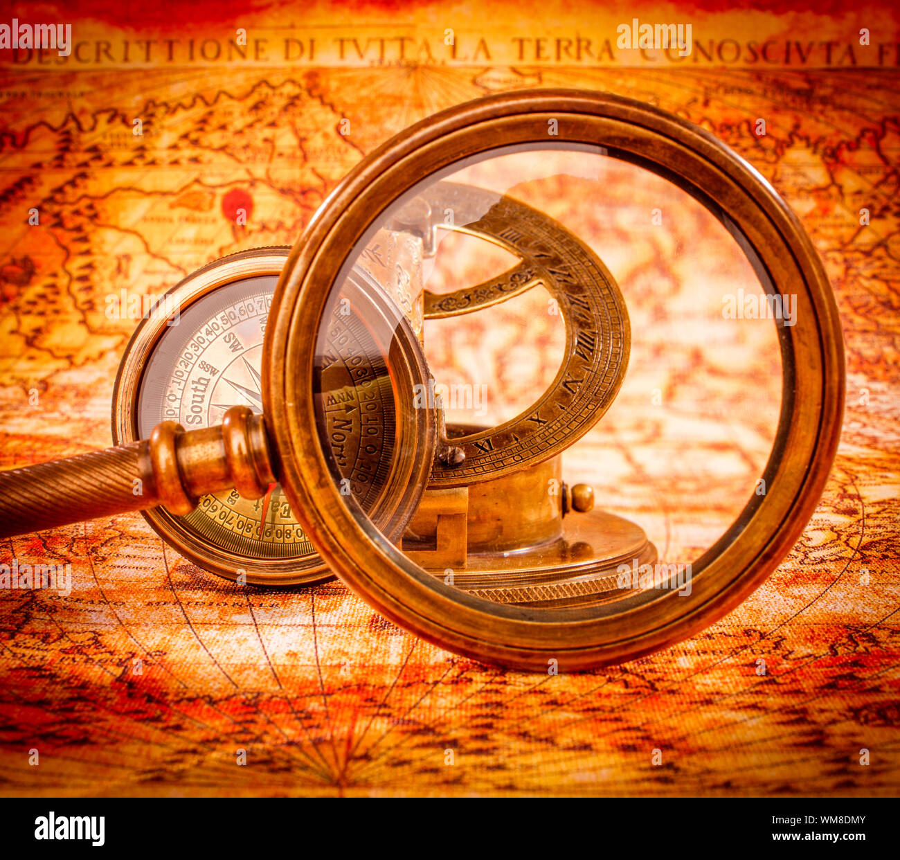 Vintage still life. Vintage magnifying glass lies on an ancient world ...