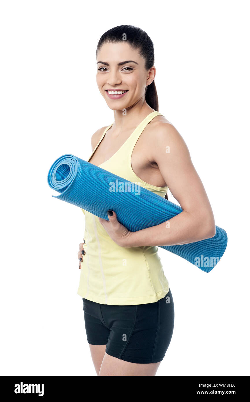 Fitness woman holding rolled up exercise mat Stock Photo - Alamy