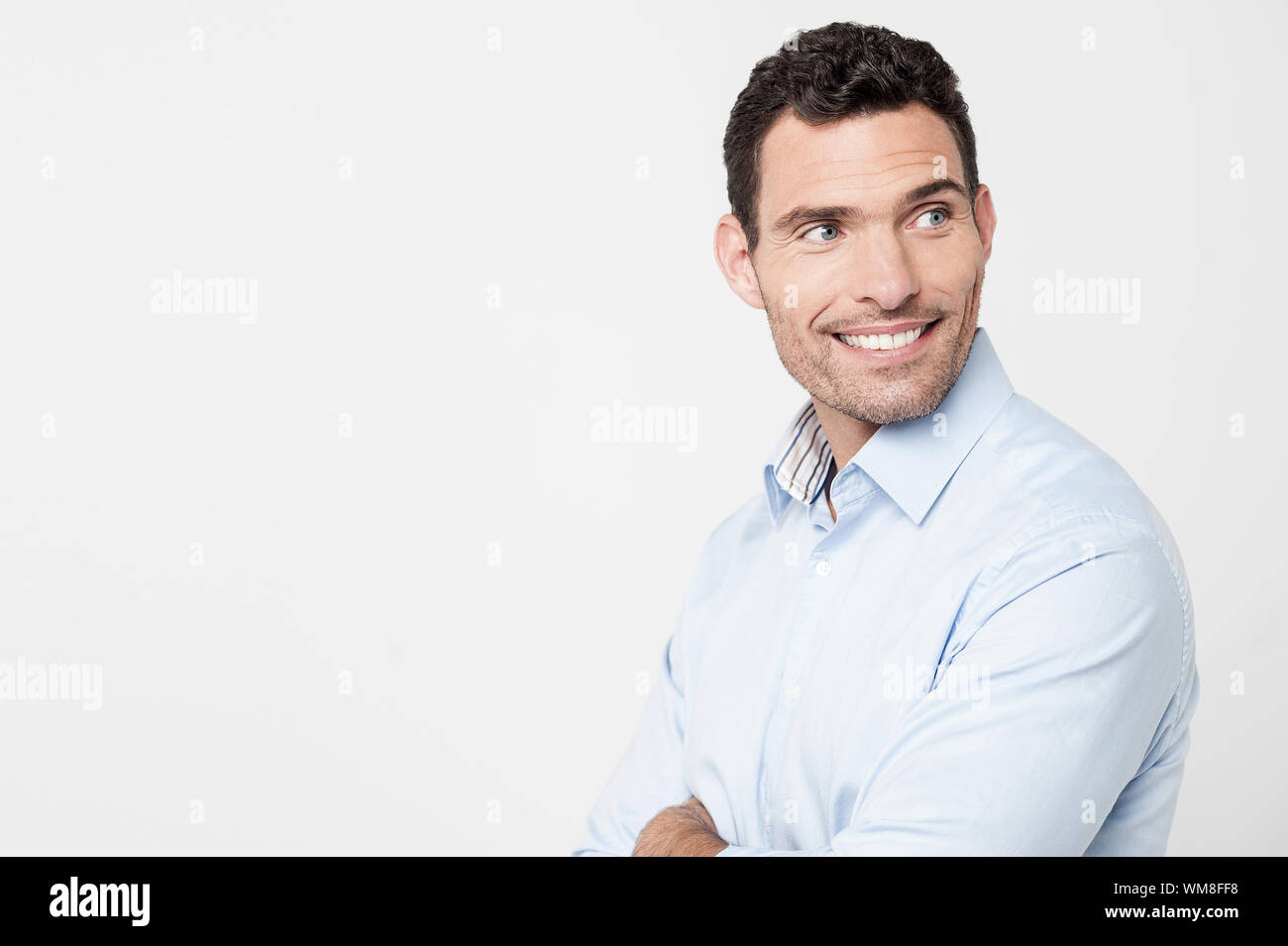 Casual young man looking back at something Stock Photo - Alamy