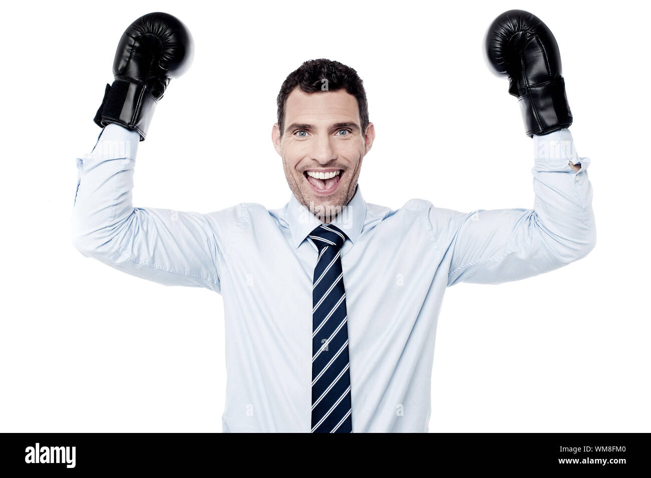 Victorious businessman raising hands with boxing gloves Stock Photo - Alamy
