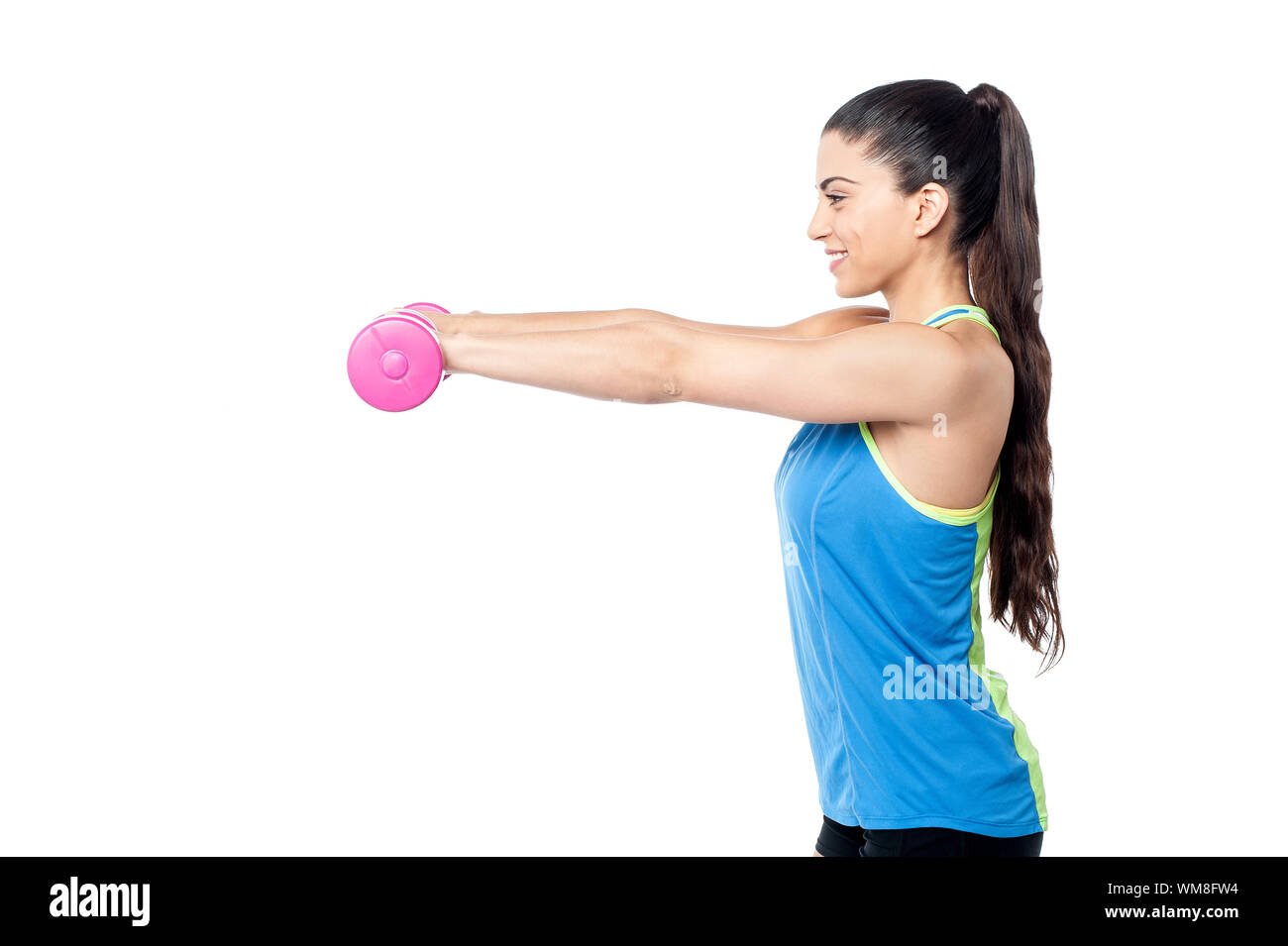 Side pose of fitness woman lifting dumbbells Stock Photo - Alamy