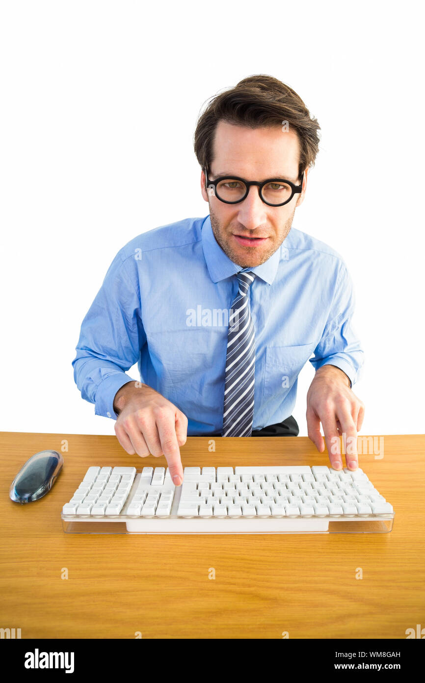Businessman typing on his keyboard wearing glasses on white background ...