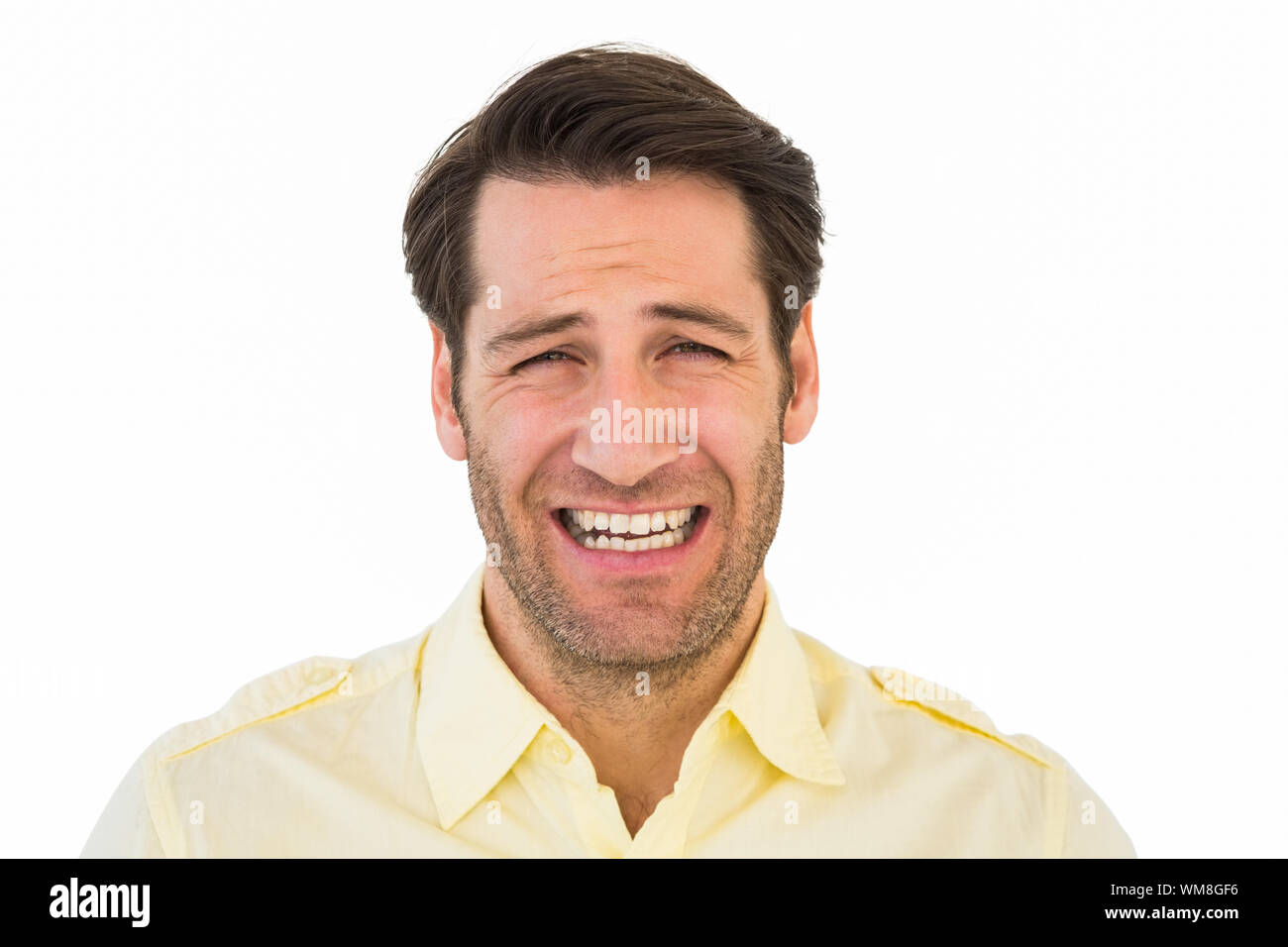 Desperate handsome man frowning at camera on white background Stock ...