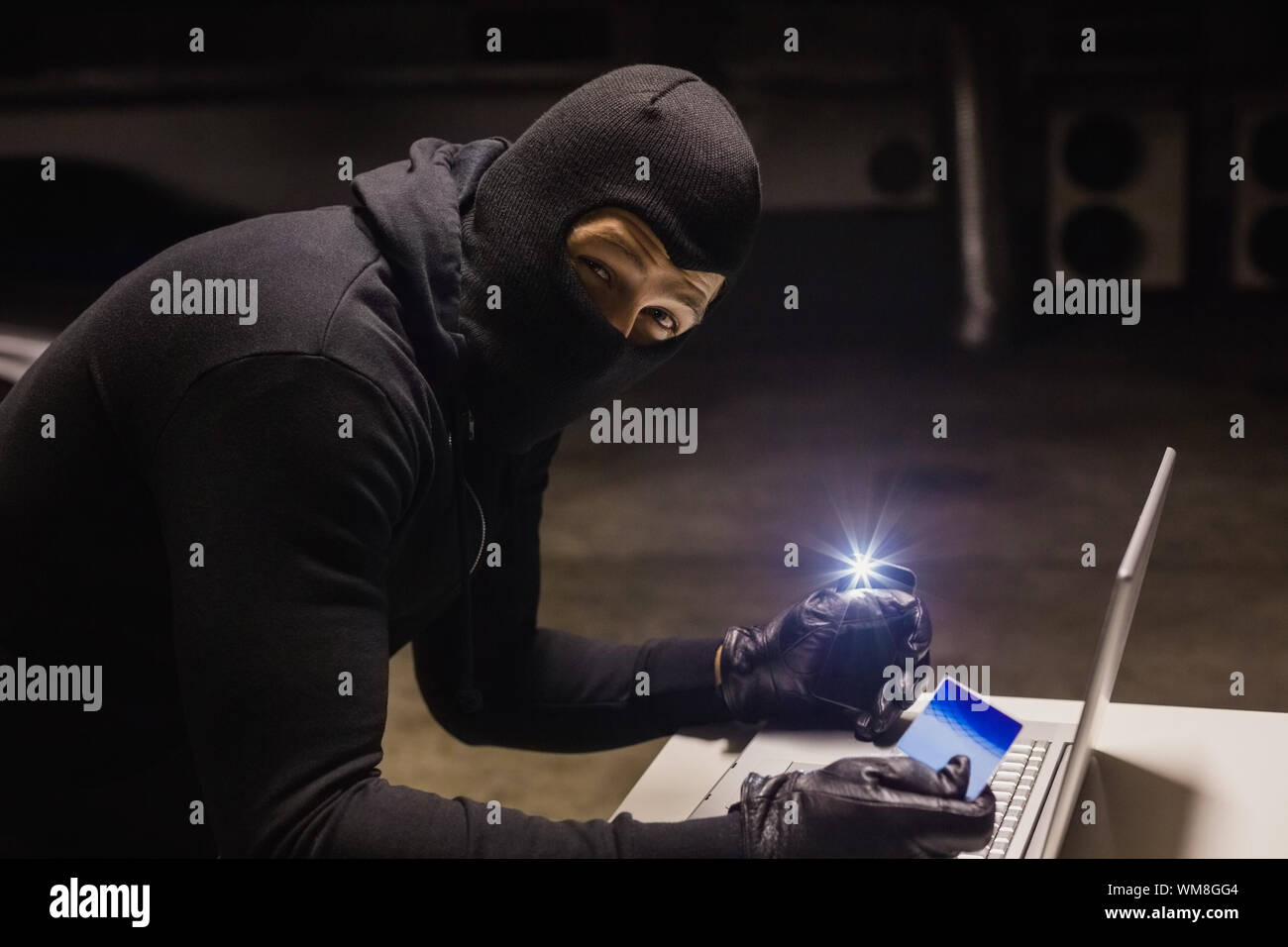 Robber shopping online while making light on black background Stock ...