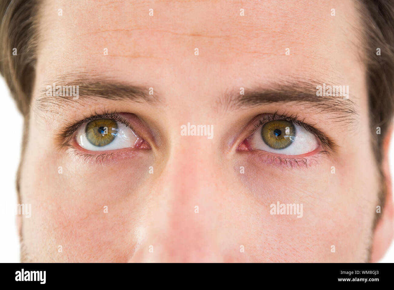 Close up of unsmiling man on white background Stock Photo - Alamy