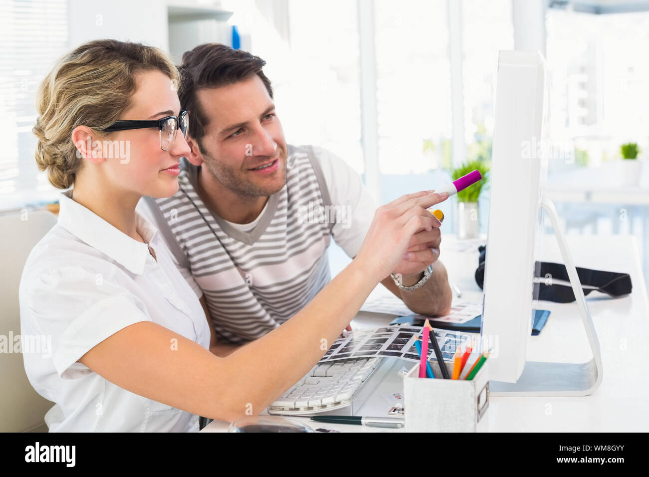 Employees pointing laptop screen hi-res stock photography and images ...
