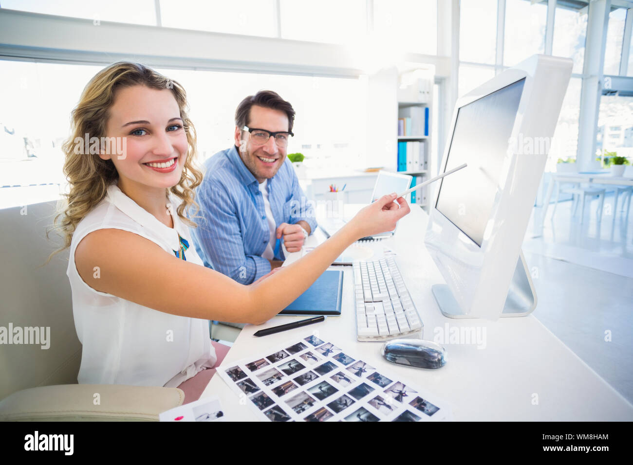 Employees pointing laptop screen hi-res stock photography and images ...