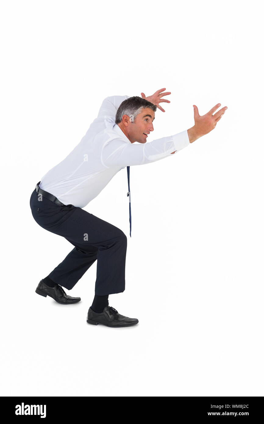 Businessman bending with arms up on white background Stock Photo - Alamy