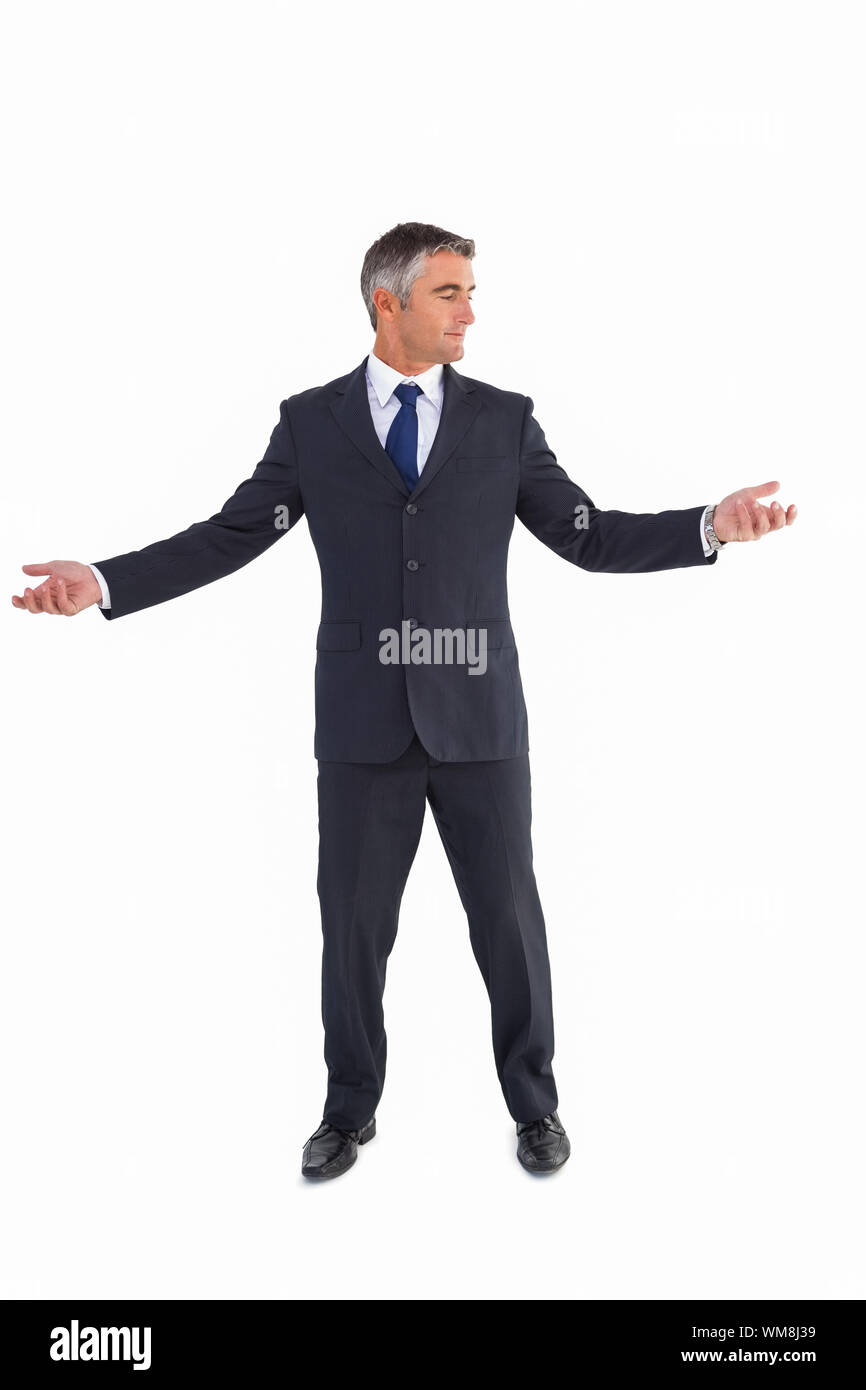 Businessman in suit spreading his arms on white background Stock Photo ...