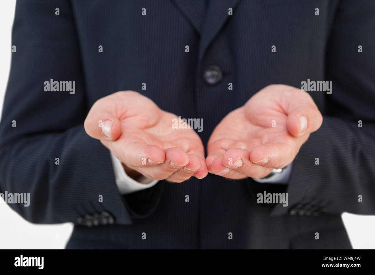 Mid section of a businessman with hands out on white background Stock ...