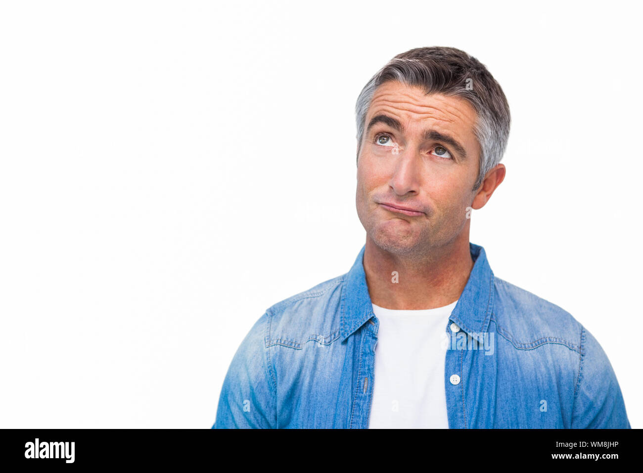 Confused man with grey hair thinking on white background Stock Photo ...