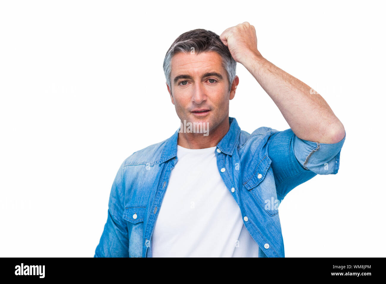 Doubtful man with his fist on head on white background Stock Photo - Alamy