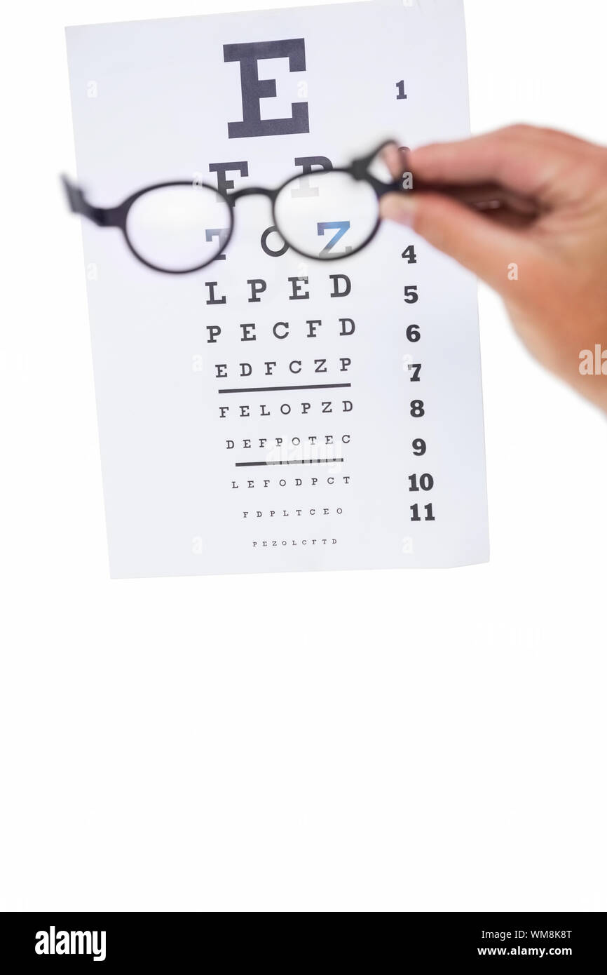 Hand holding glasses for a eye test on white background Stock Photo - Alamy
