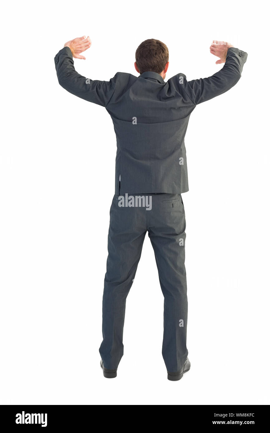 Businessman standing with hands up on white background Stock Photo - Alamy