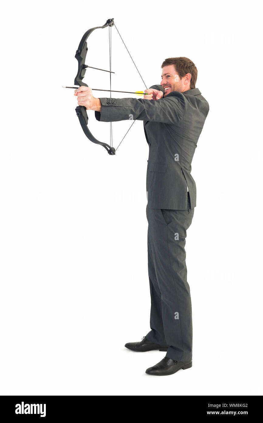 Businessman shooting a bow and arrow on white background Stock Photo ...
