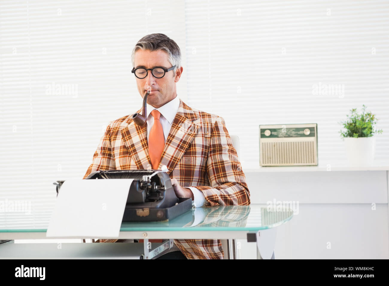Retro man typing on typewriter in his office Stock Photo - Alamy