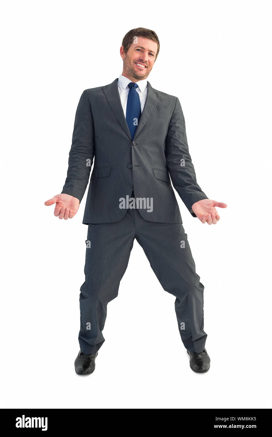 Businessman smiling with hands out on white background Stock Photo - Alamy
