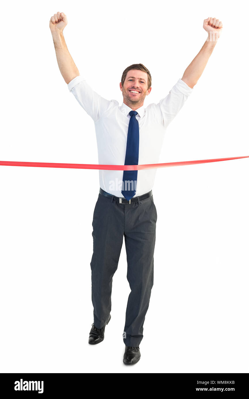 Businessman crossing the finish line on white background Stock Photo ...