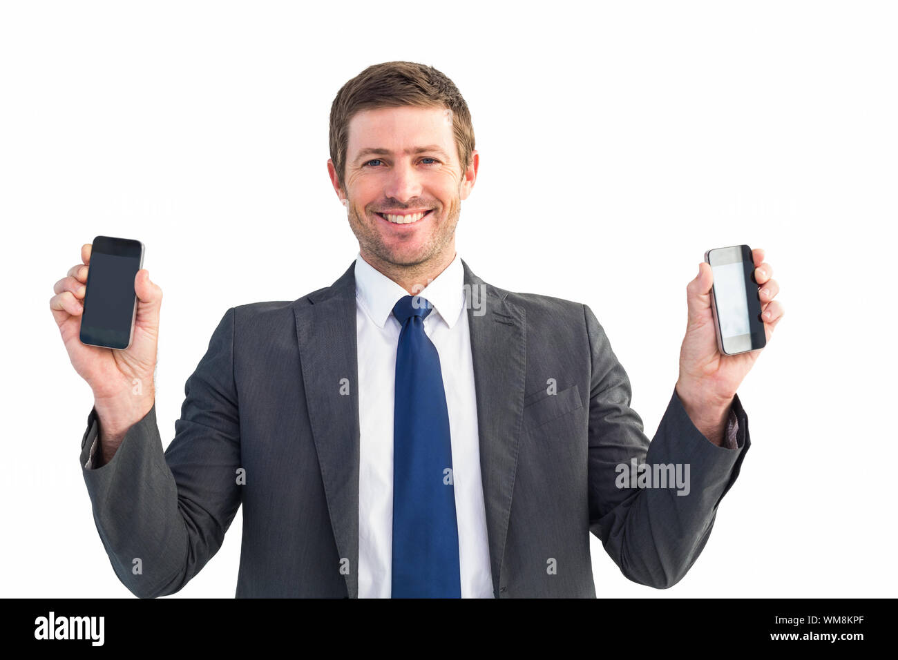 Businessman holding two smart phones on white background Stock Photo ...