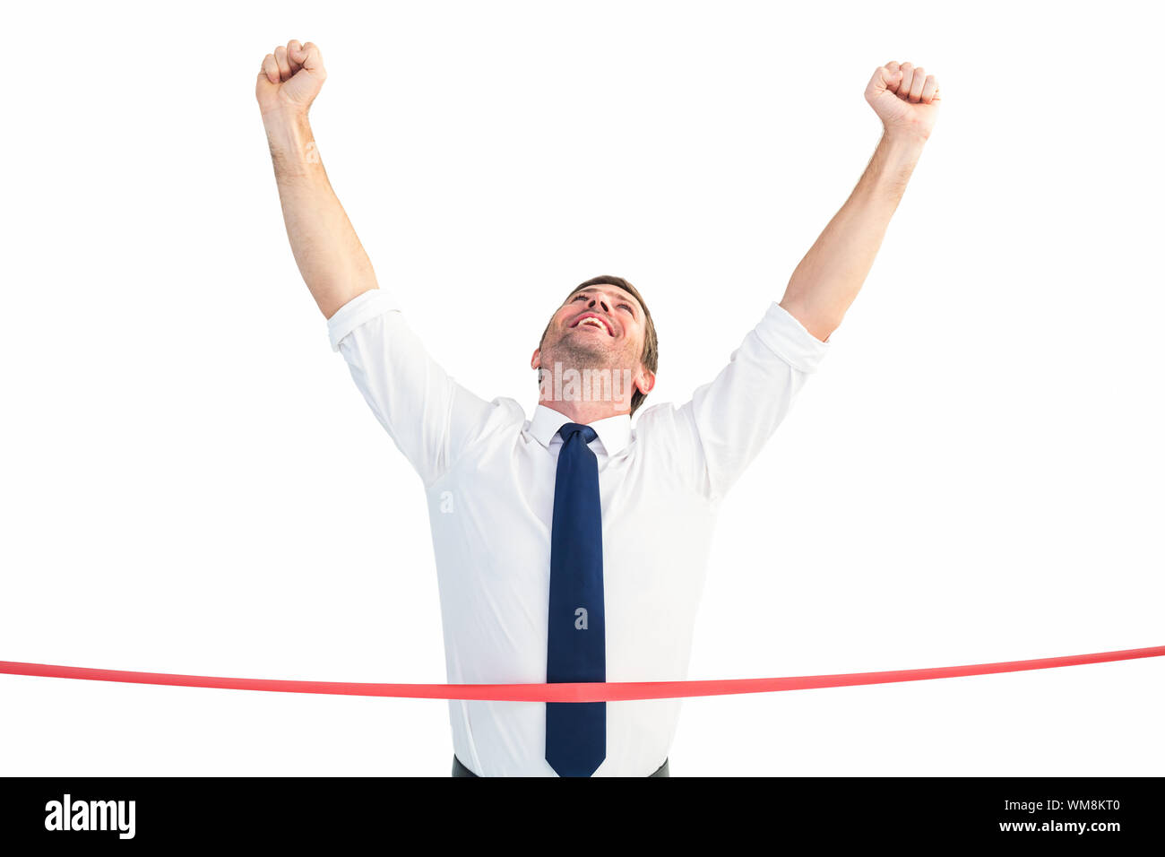 Businessman crossing the finish line on white background Stock Photo ...