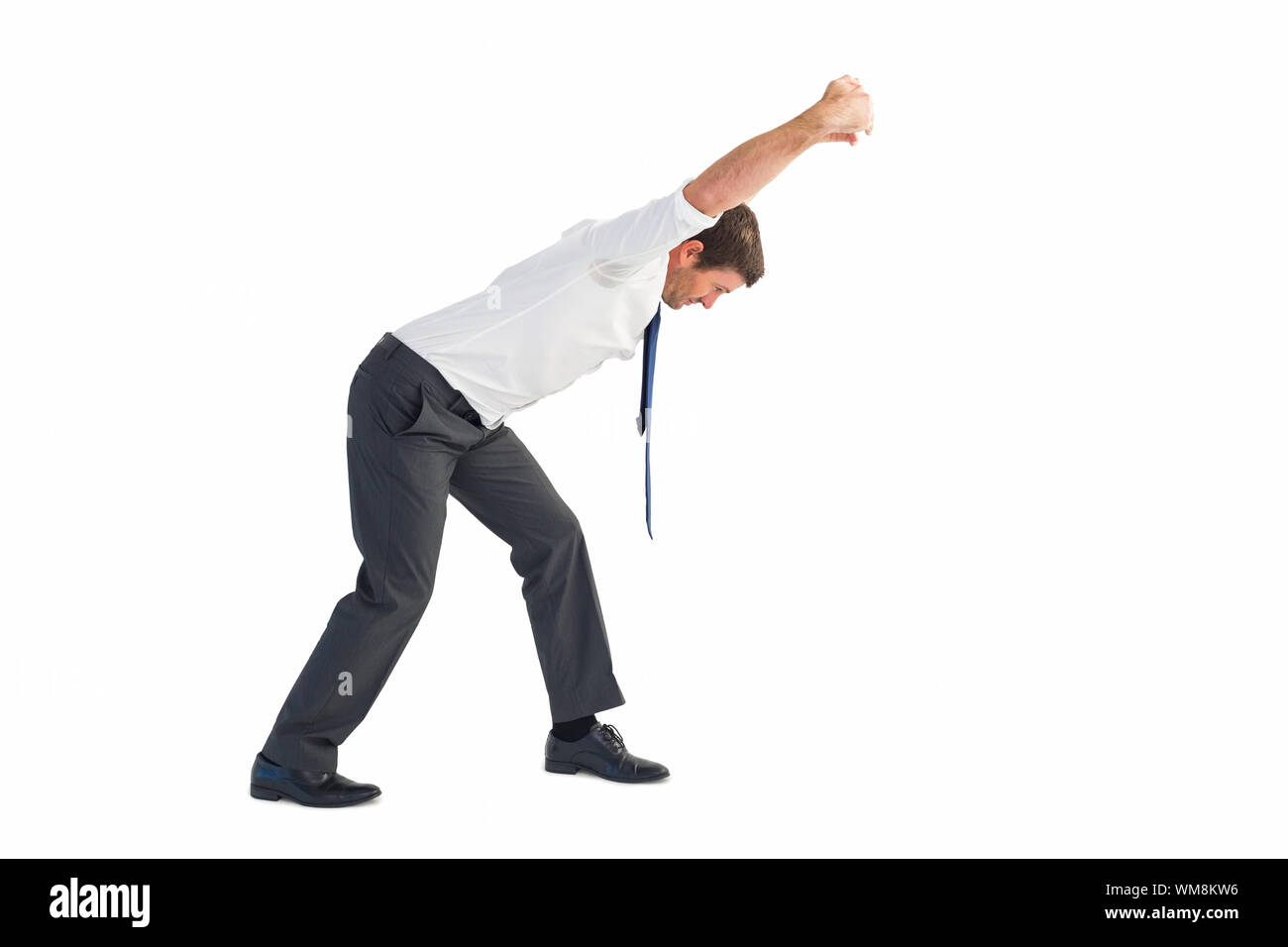 Businessman bending and pushing on white background Stock Photo - Alamy