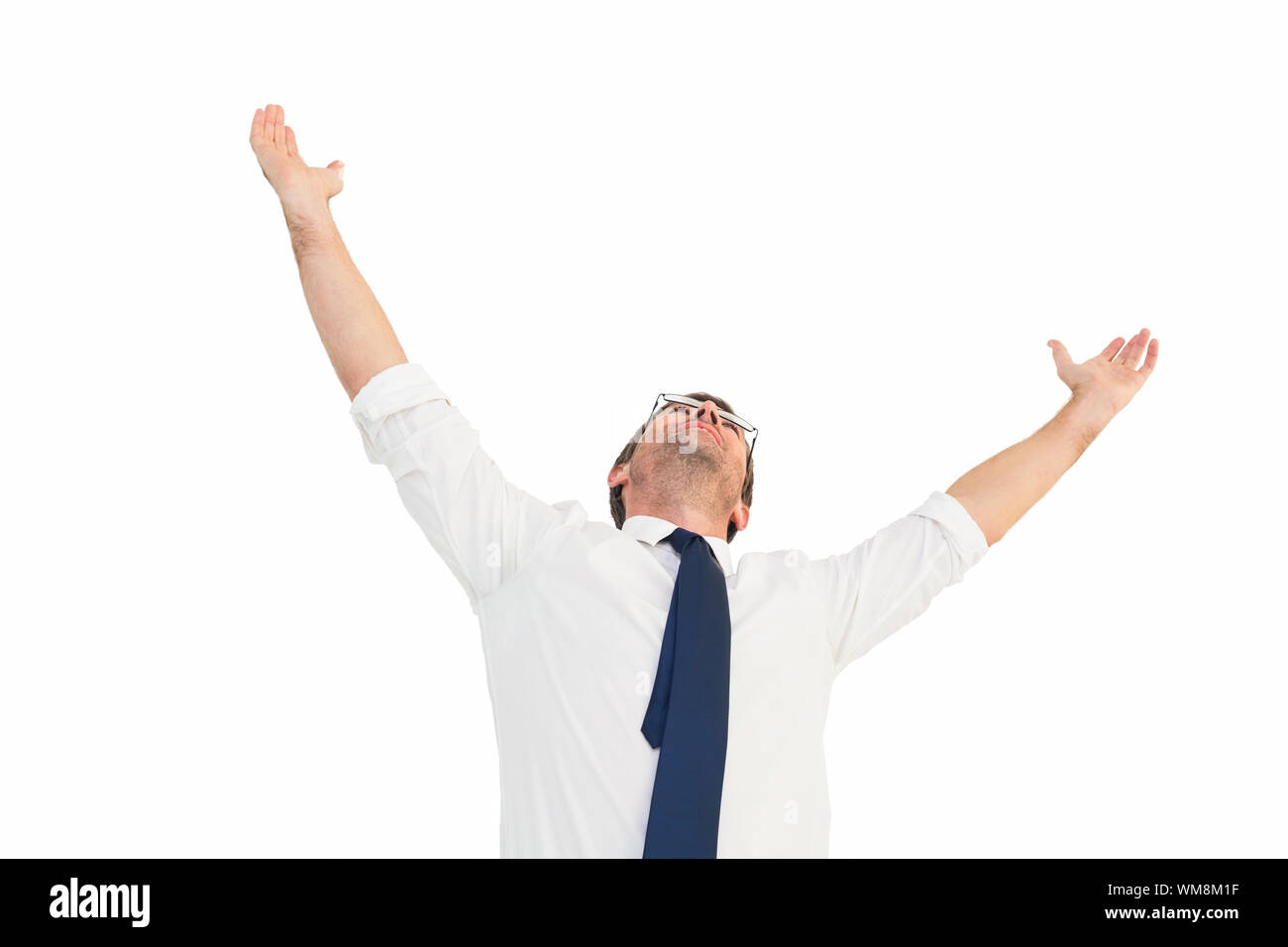 Handsome businessman cheering with arms up on white background Stock ...