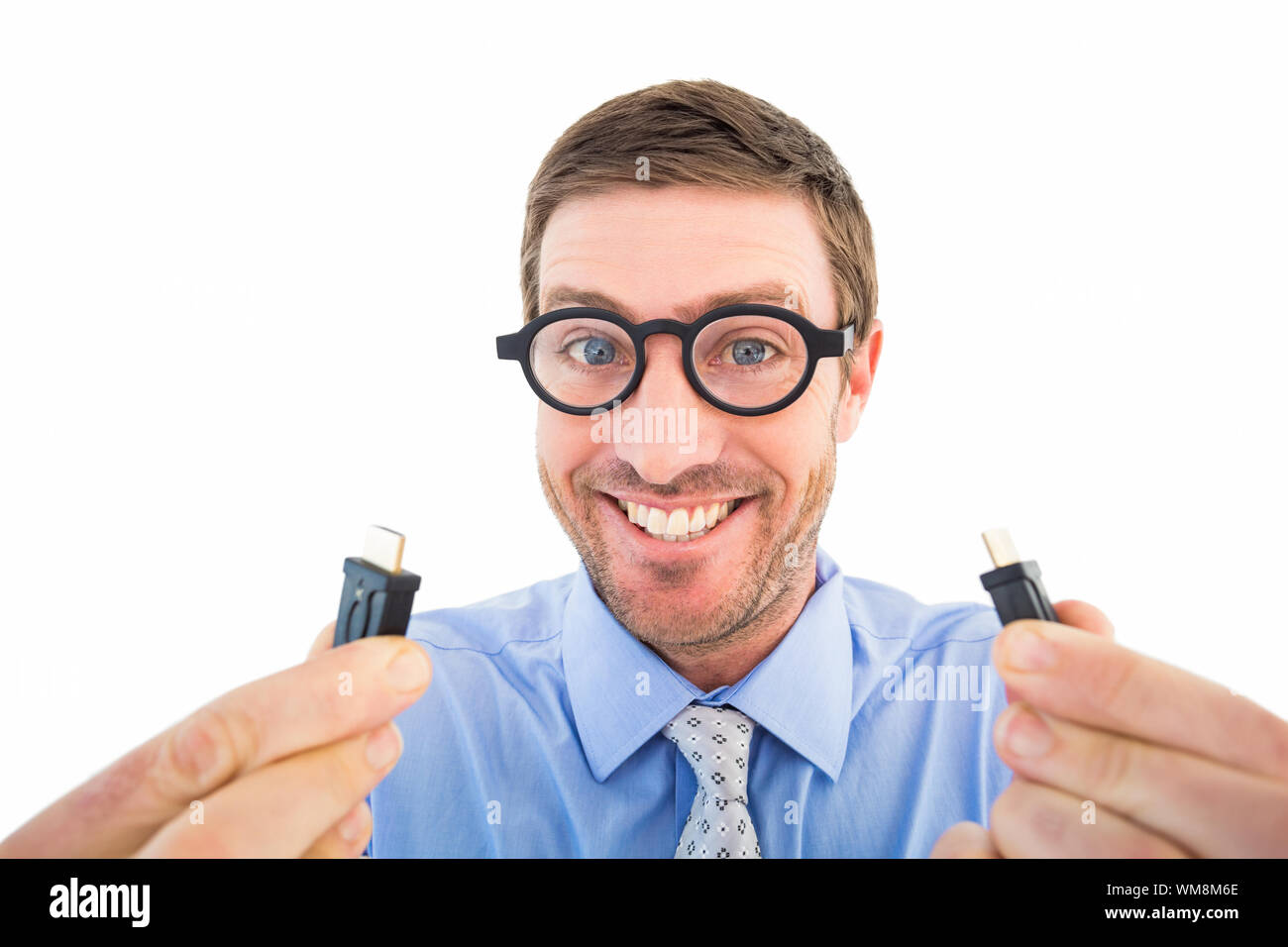 Geeky businessman holding two cables on white background Stock Photo ...