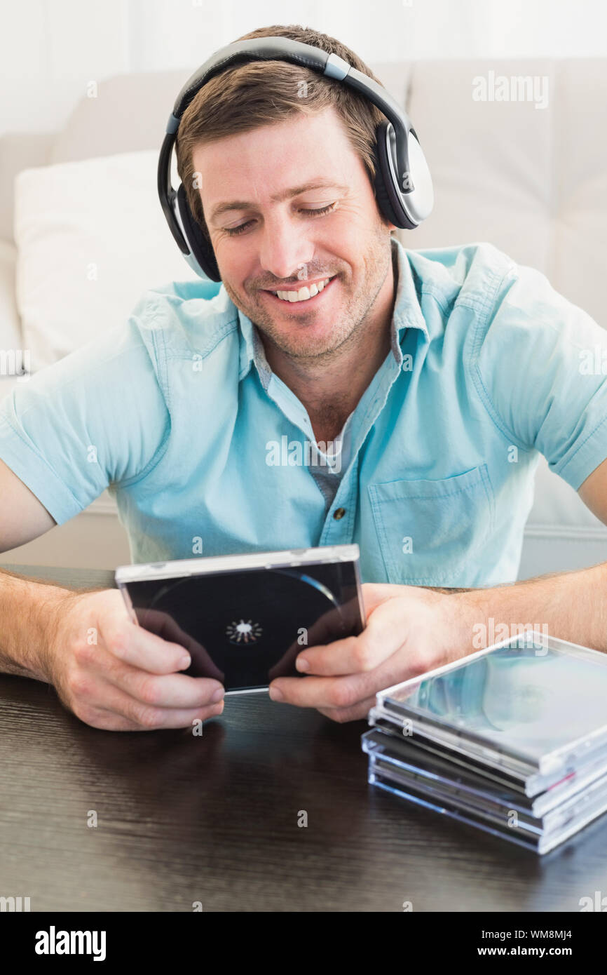 A man listening to cds at home in the living room Stock Photo - Alamy