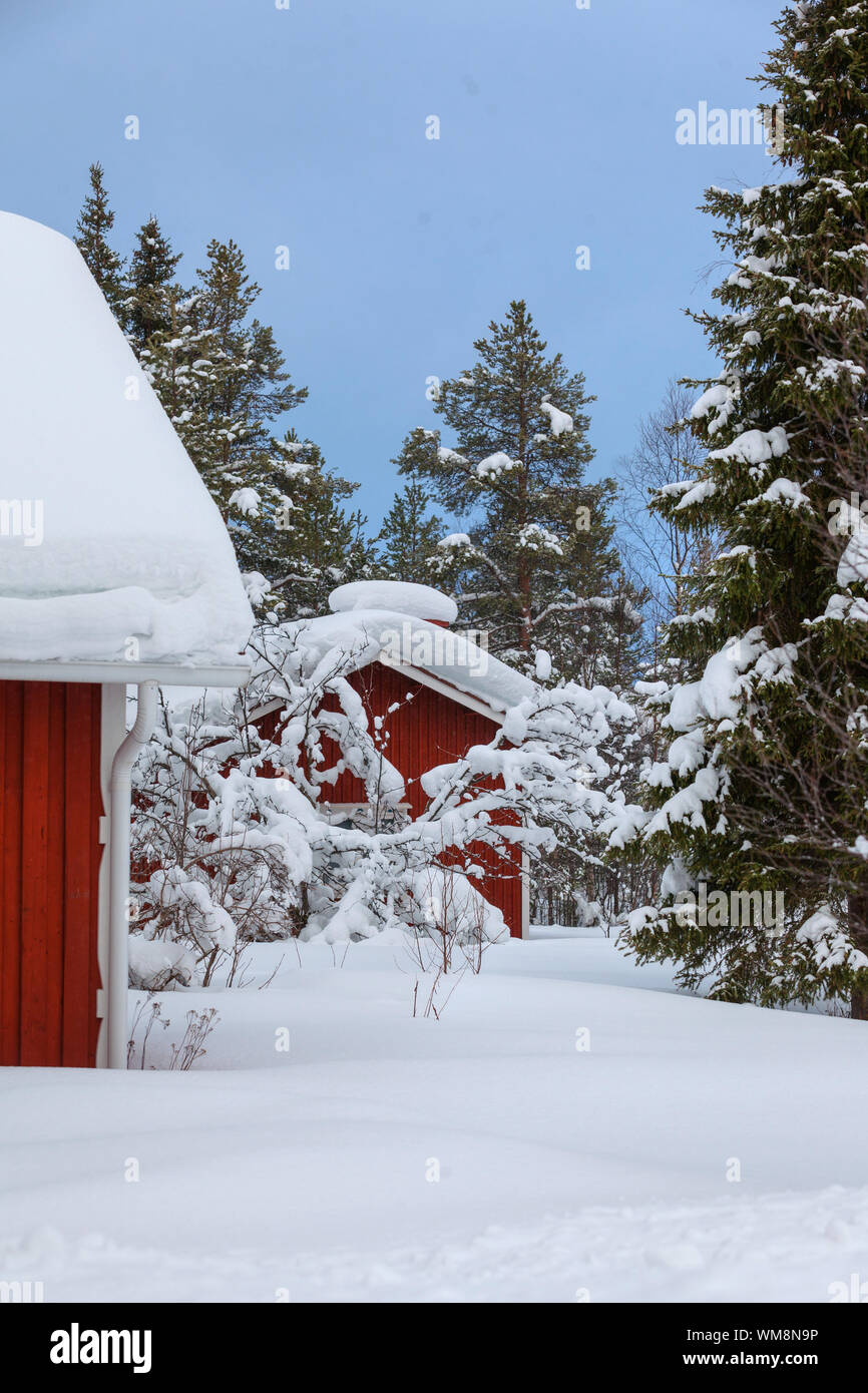 Red wooden Finnish house in winter forest covered with snow Stock Photo ...